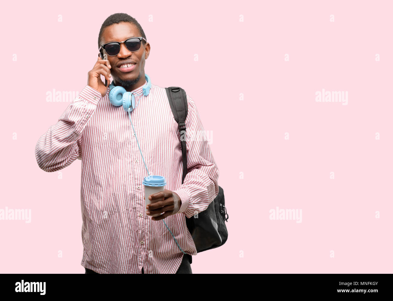 African black man student happy talking using a smartphone mobile phone ...