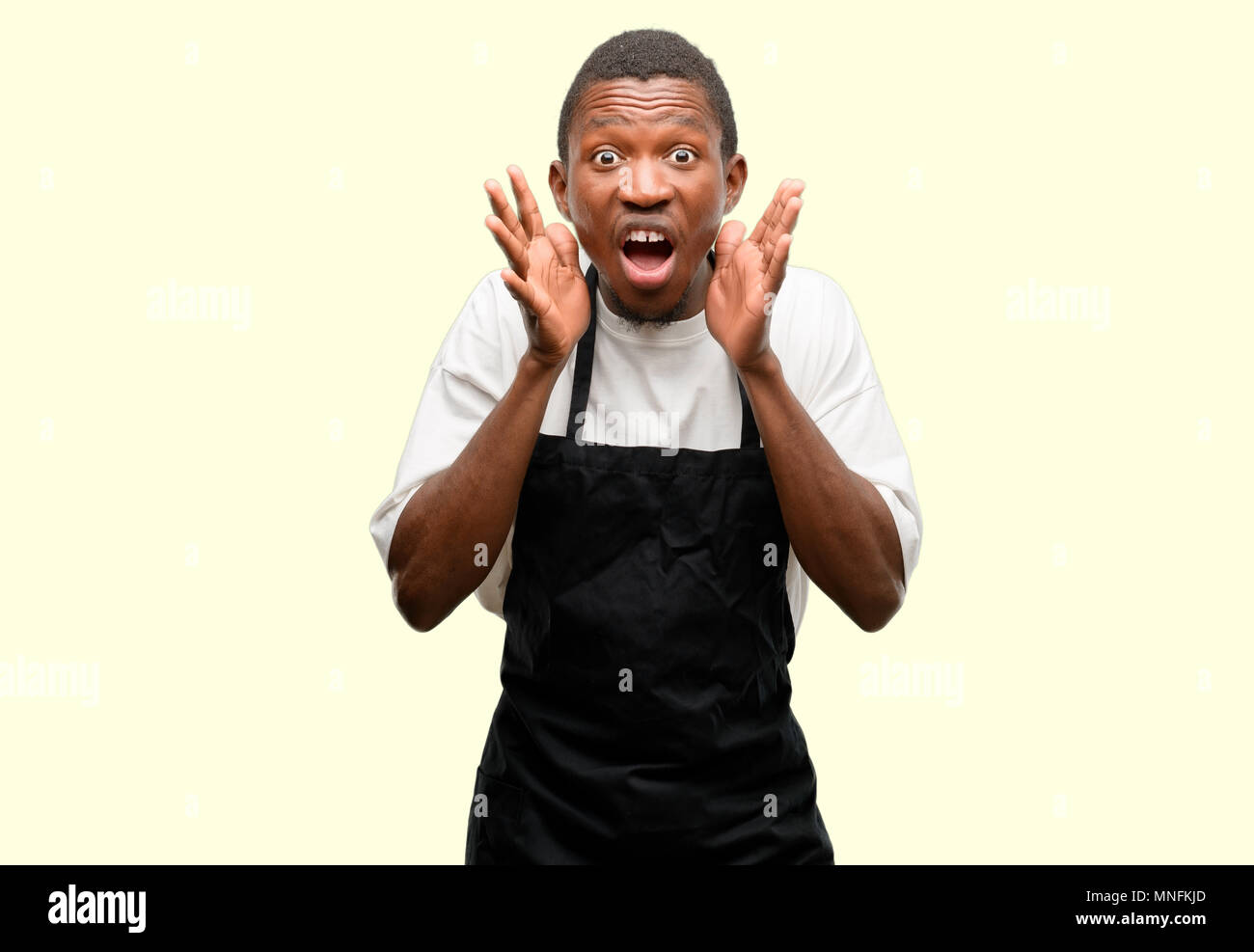 African man shop owner wearing apron stressful keeping hands on head ...