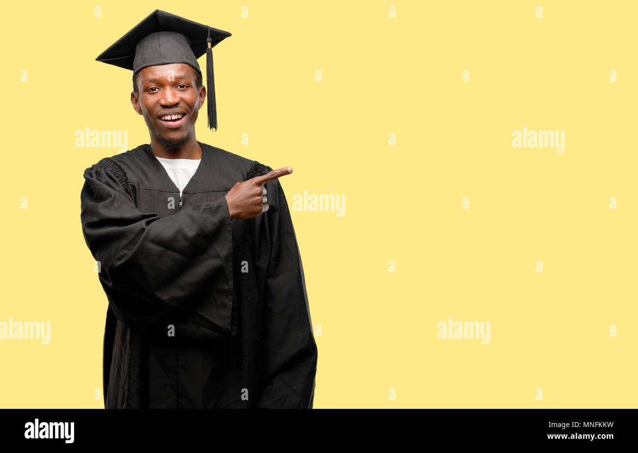 Young african graduate student black man pointing away side with finger ...