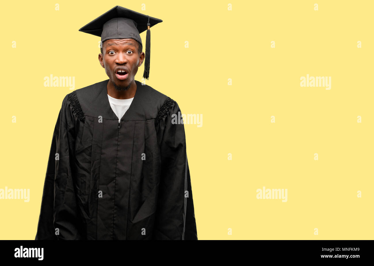 Young african graduate student black man scared in shock, expressing ...
