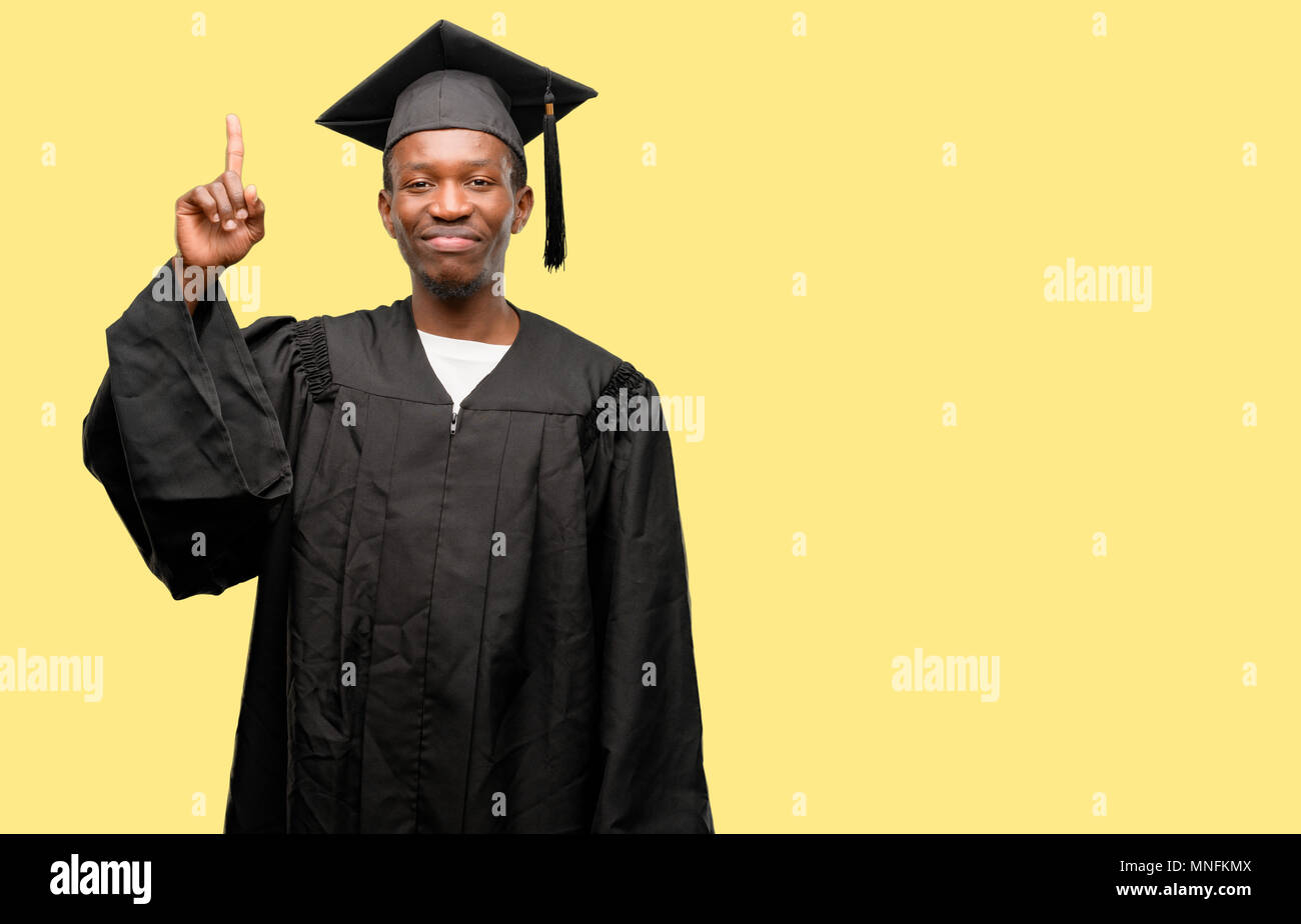 Young african graduate student black man raising finger, the number one ...