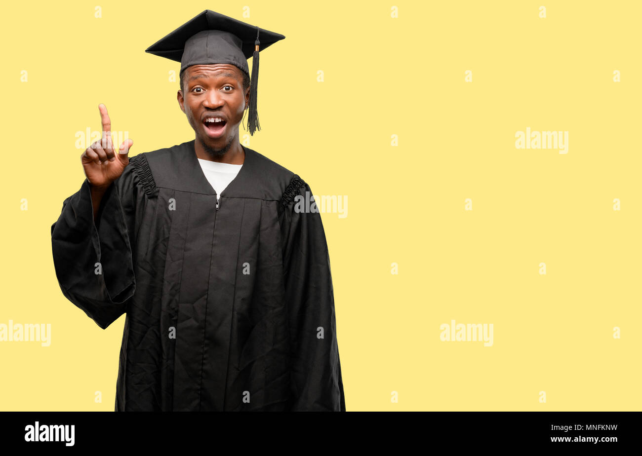 Young african graduate student black man pointing away side with finger ...