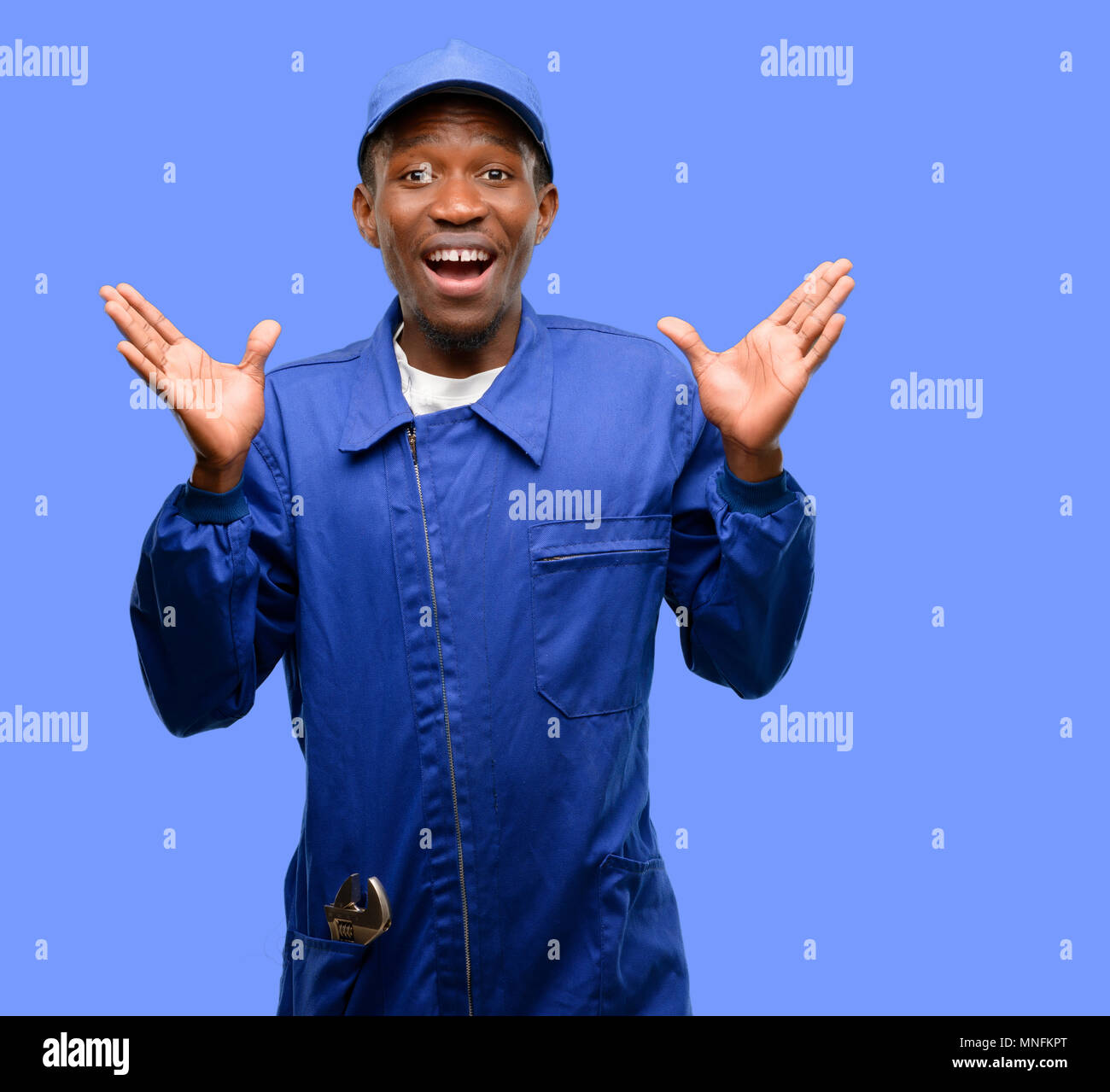 African black plumber man happy and surprised cheering expressing wow ...