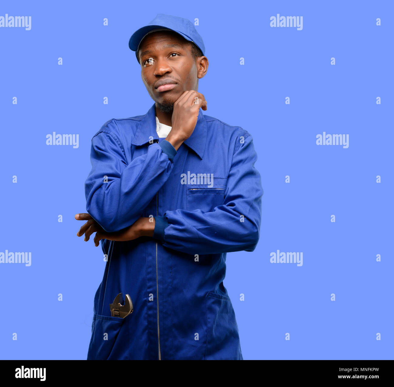 African black plumber man thinking and looking up expressing doubt and ...