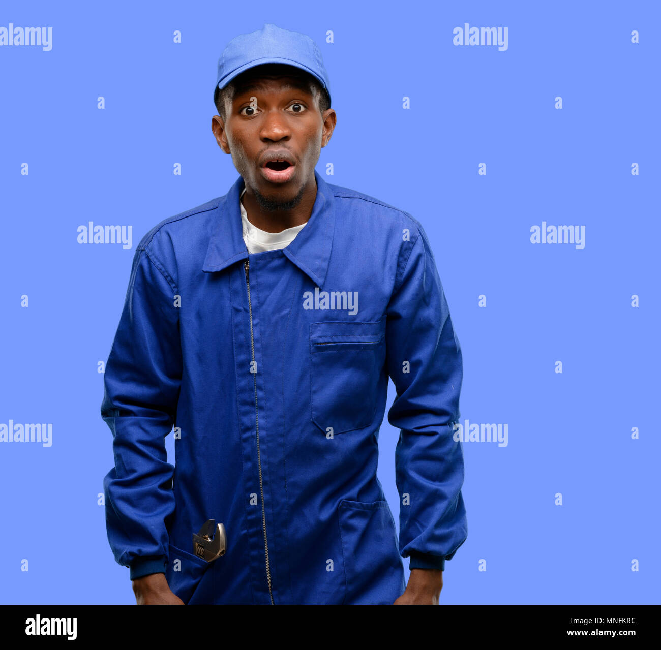 African black plumber man scared in shock, expressing panic and fear ...