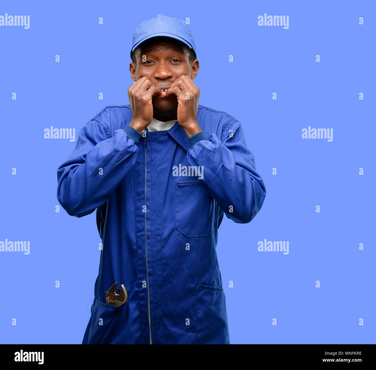 African black plumber man terrified and nervous expressing anxiety and ...