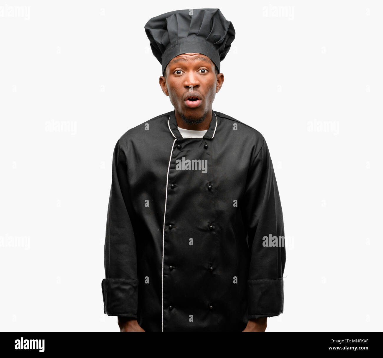 Young black cook wearing chef hat scared in shock, expressing panic and ...