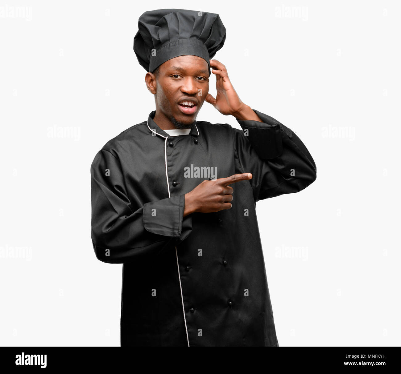 Young black cook wearing chef hat pointing away side with finger Stock ...