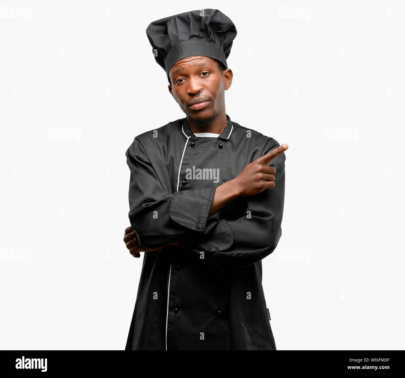 Young black cook wearing chef hat pointing away side with finger Stock ...