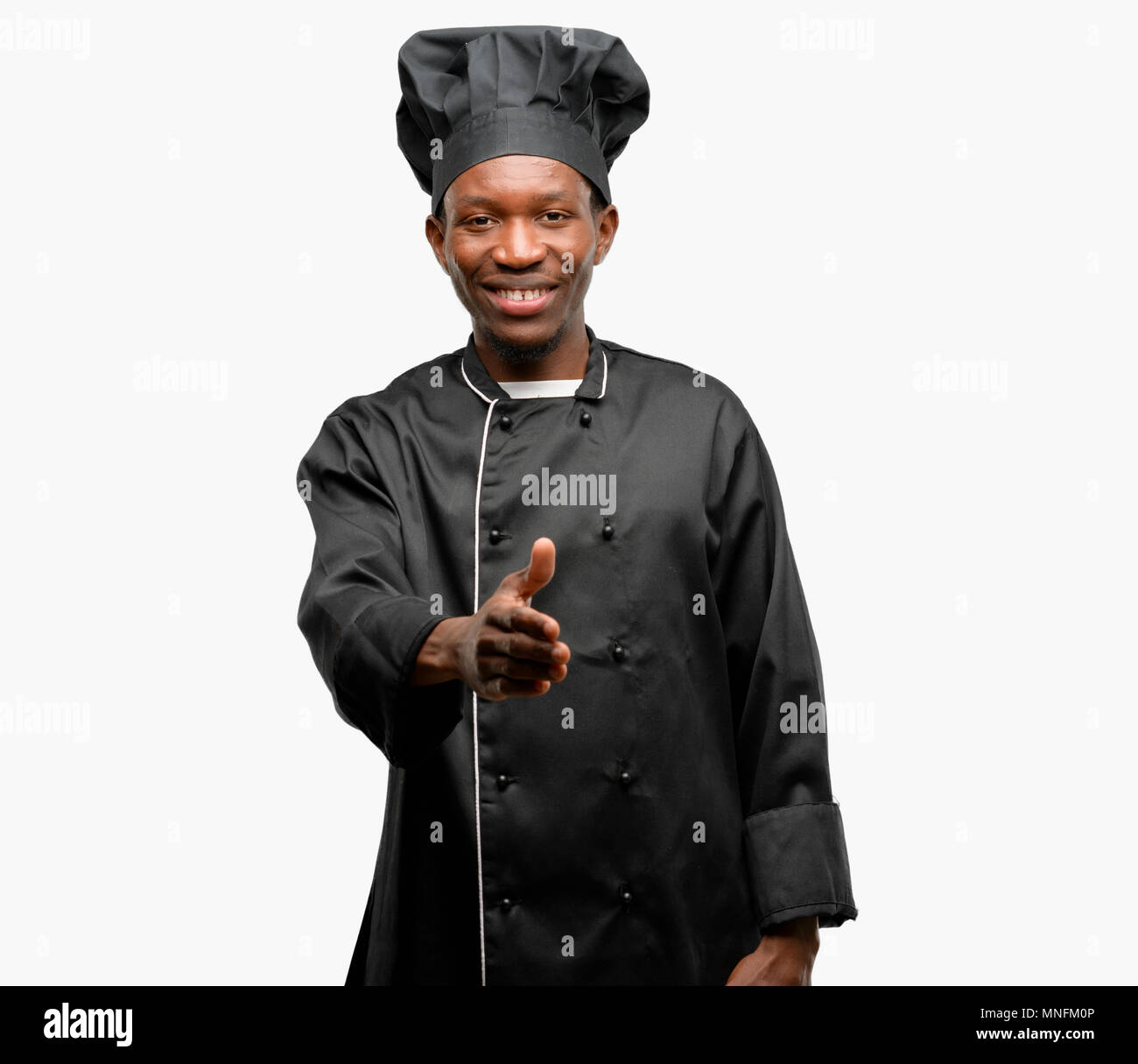 Young black cook wearing chef hat holds hands welcoming in handshake ...