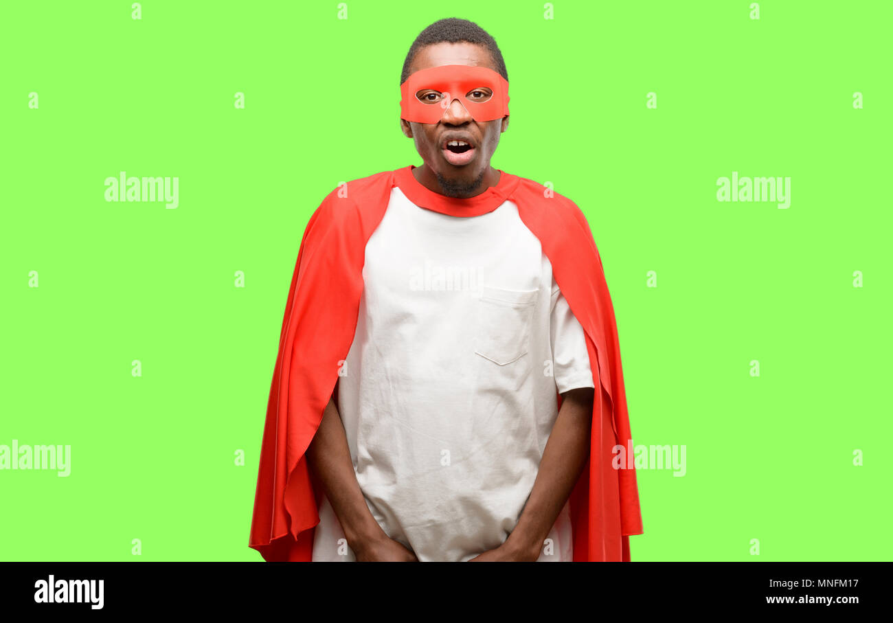 African black super hero man scared in shock, expressing panic and fear ...