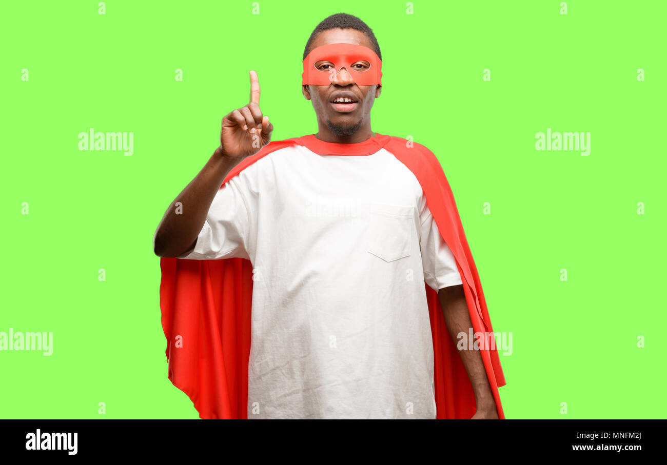 African black super hero man raising finger, the number one Stock Photo ...