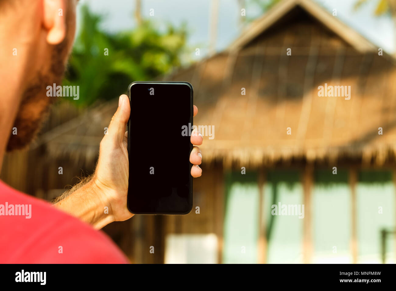 first eye view man using smart phone, cellphone on the beach on ...
