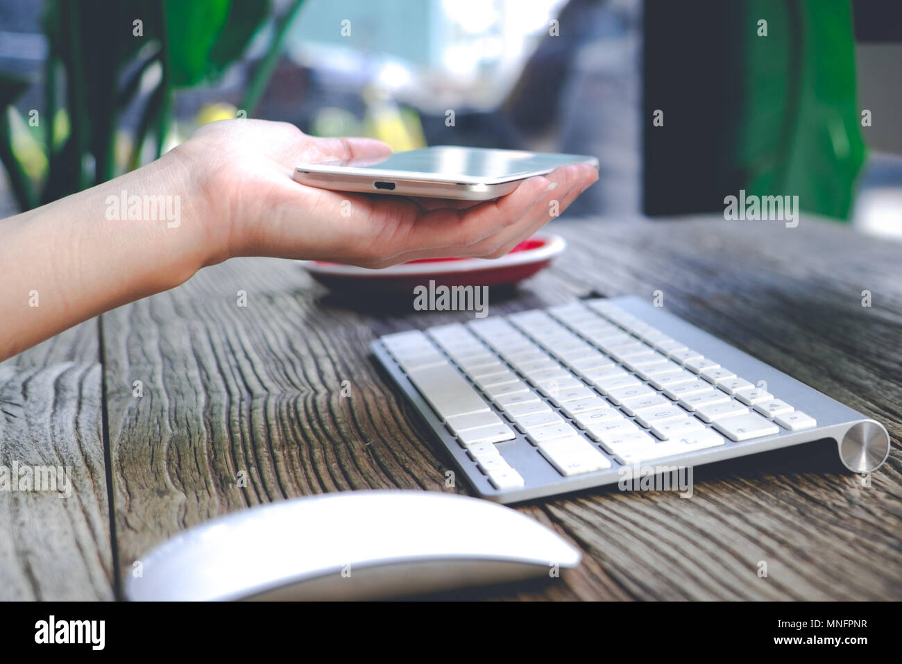 the woman hand holding the smart mobile phone with the keyboard and ...