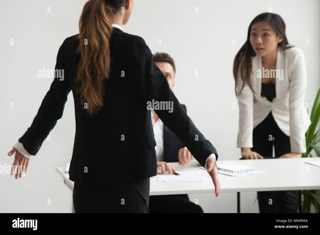 Female worker blamed by colleagues in business failure Stock Photo - Alamy