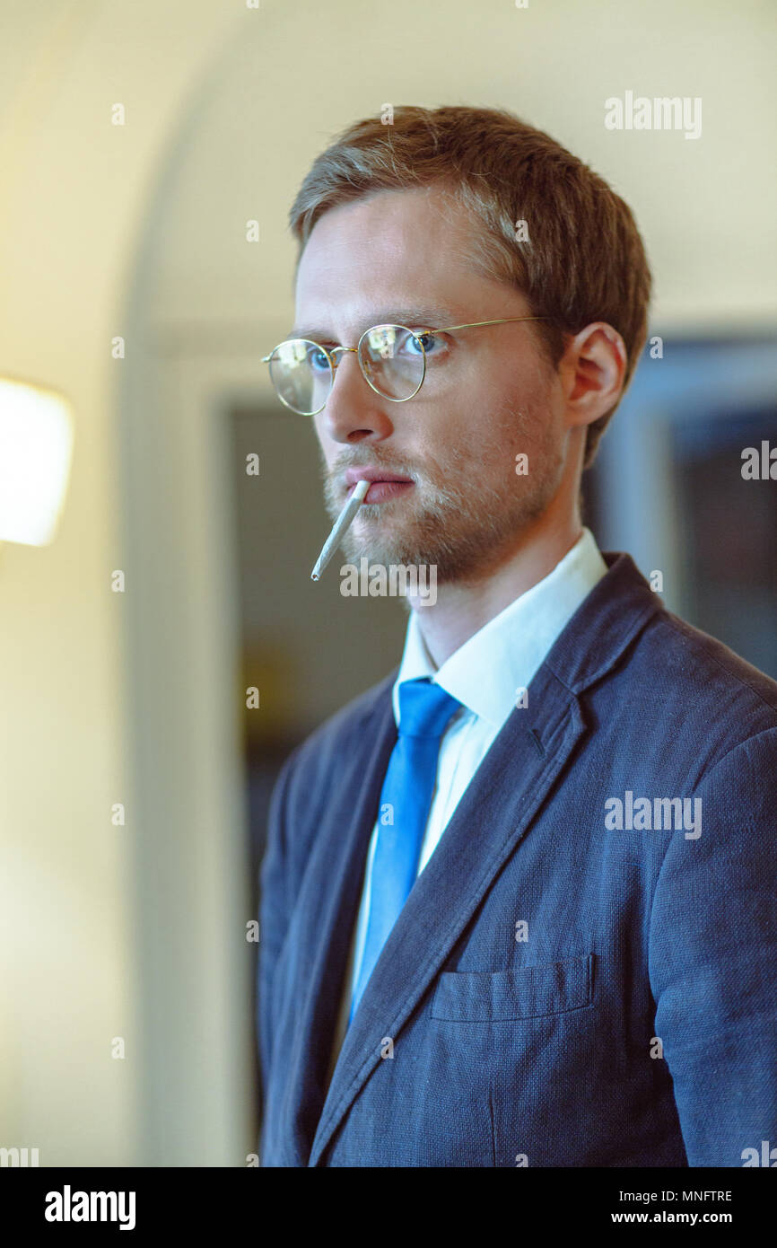 Businessman smoking cigarette Stock Photo - Alamy
