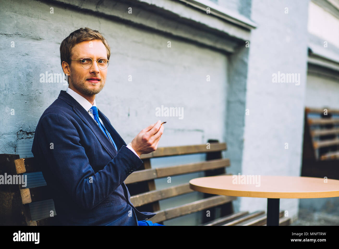Businessman smoking cigarette Stock Photo - Alamy