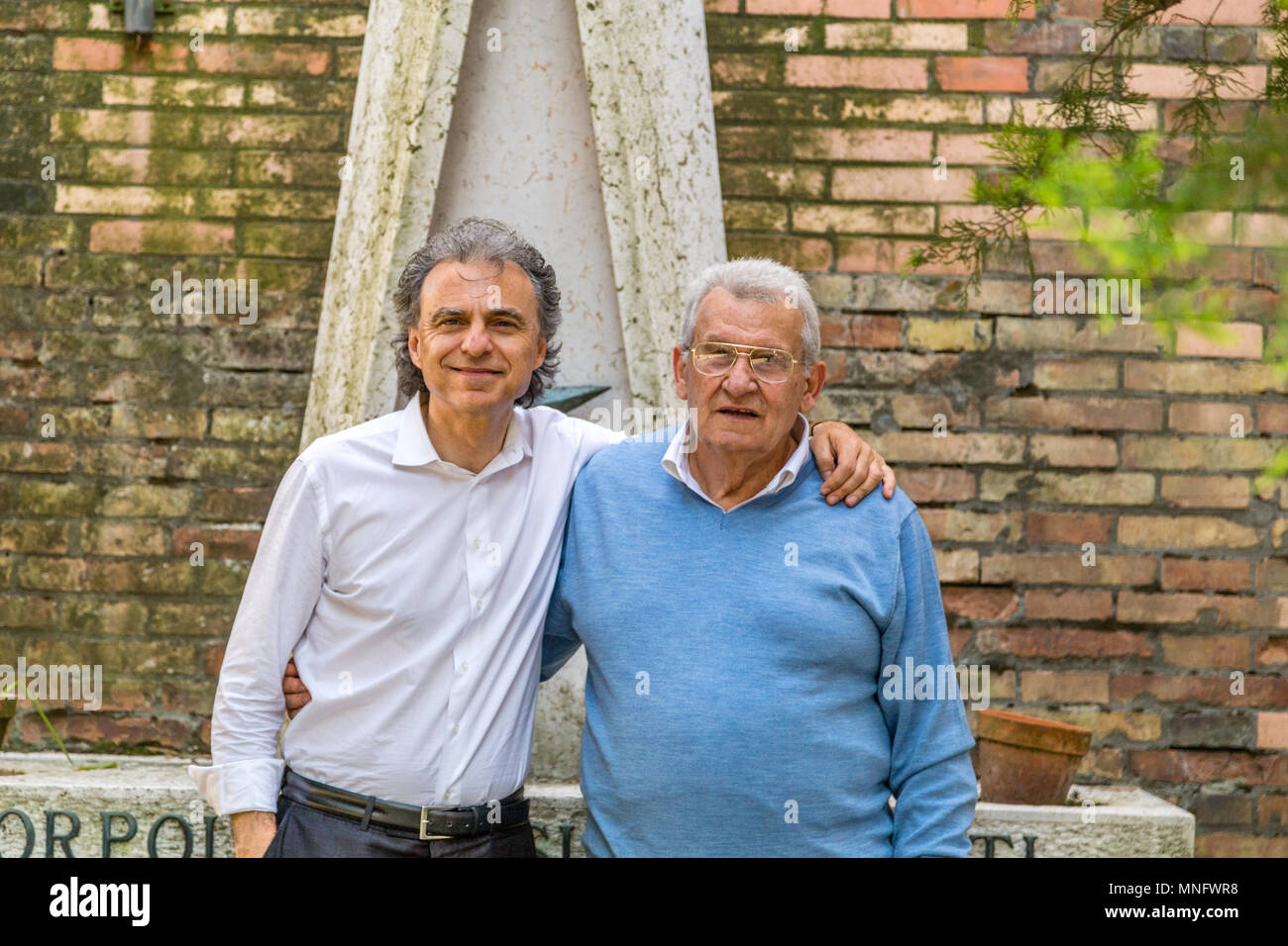 young man hugs an old man Stock Photo - Alamy