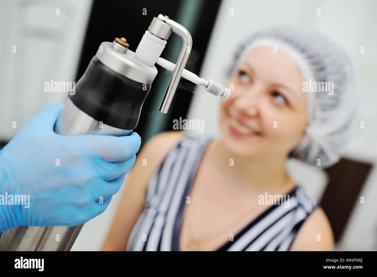 Doctor makes the patient cryotherapy procedure - Cryomassage - cold ...