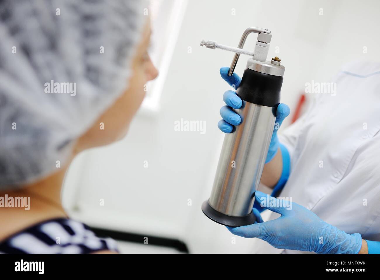 Doctor makes the patient cryotherapy procedure - Cryomassage - cold ...