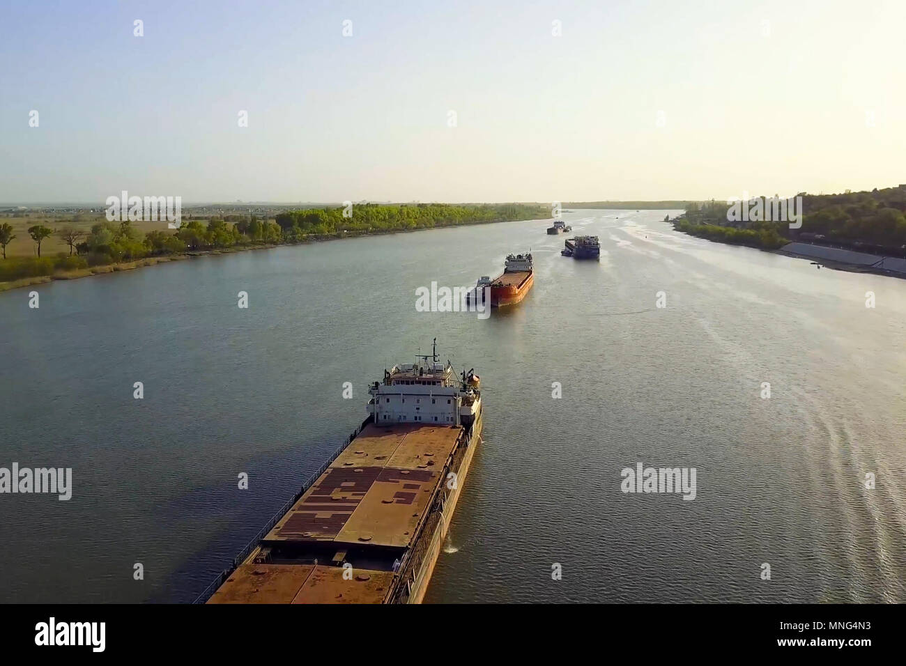 A cargo barge floats along the river. Cargo ship Stock Photo - Alamy