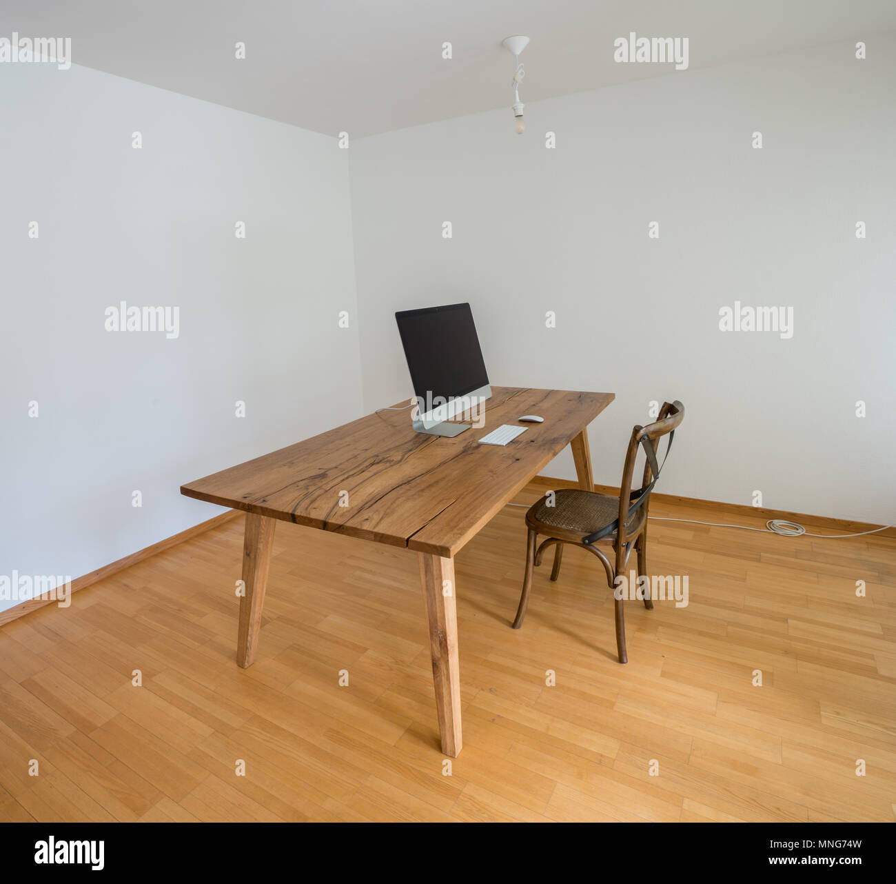 minimalist office with table and chair and computer Stock Photo - Alamy