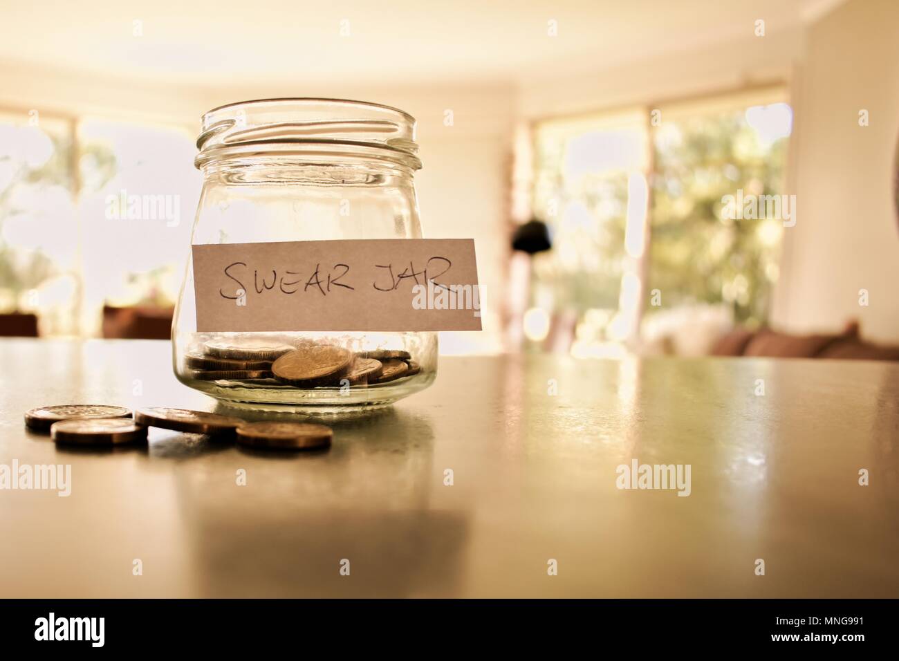 Swear jar filled with coins Stock Photo - Alamy