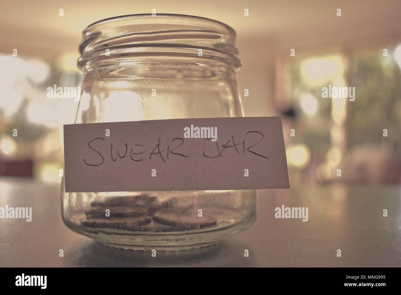 Swear jar filled with coins Stock Photo - Alamy