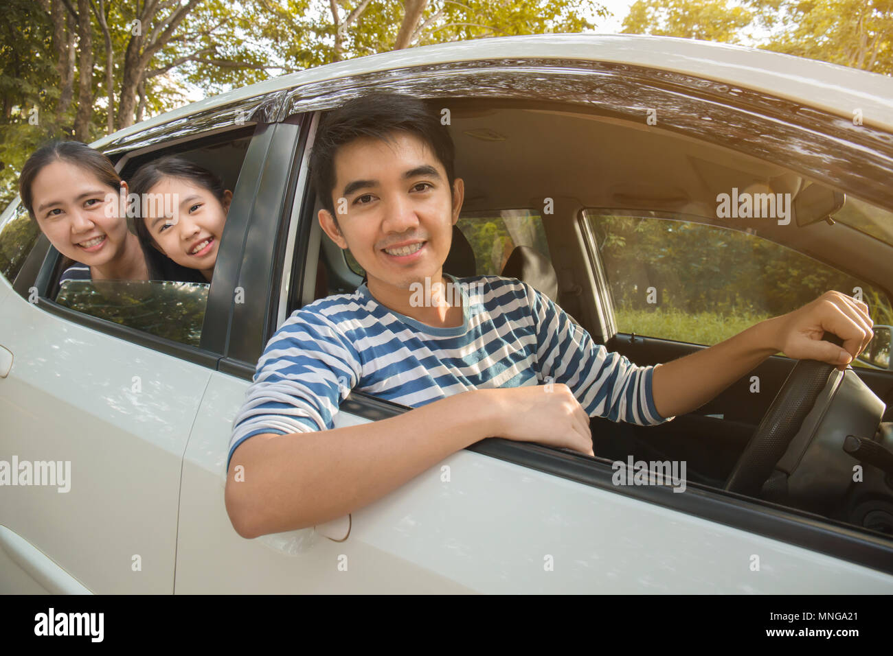 Happy Asian family on mini van are smiling and driving for travel on ...