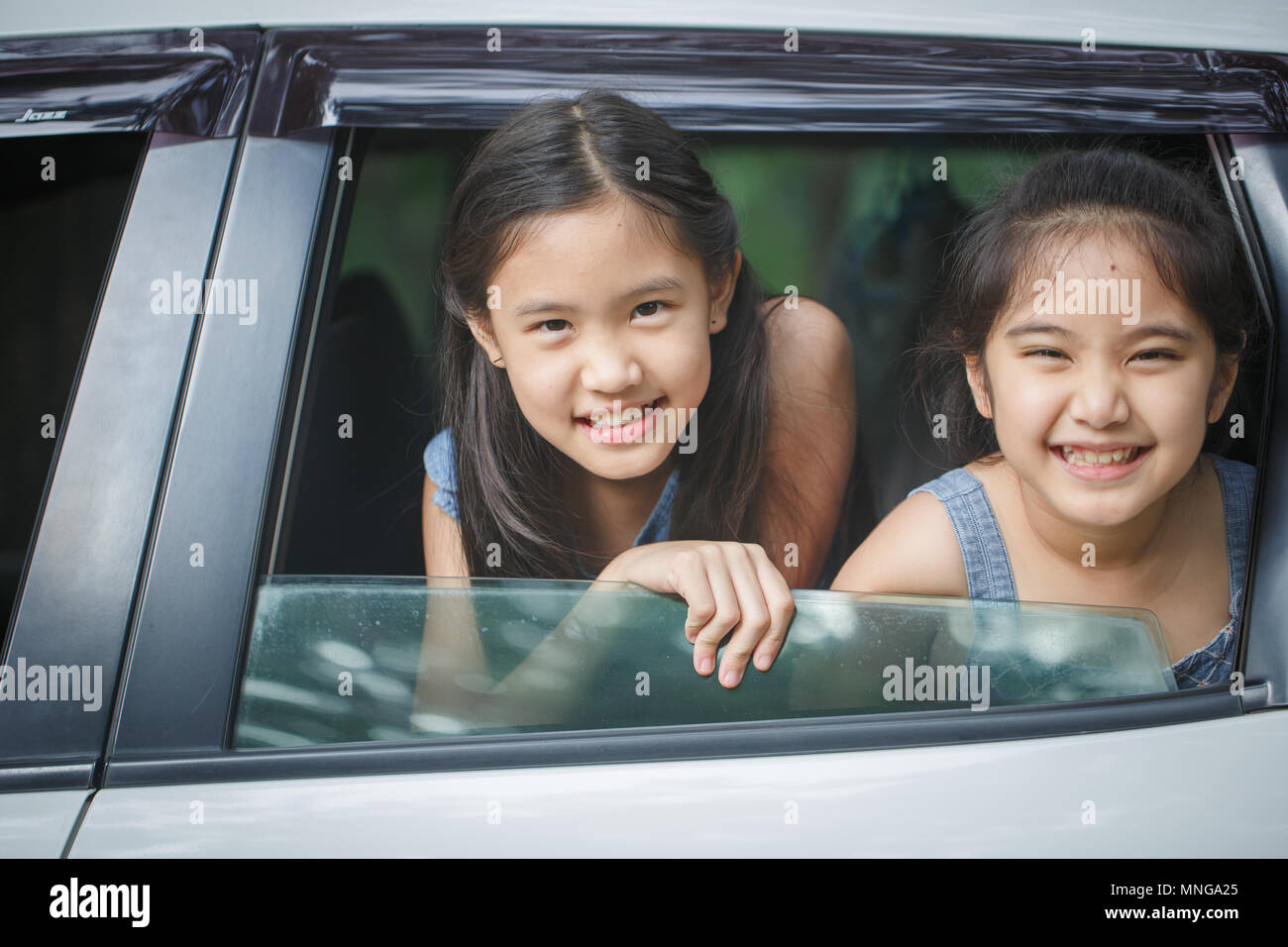Happy Asian girl smiling on mini van window, Family traveling on summer Stock Photo - Alamy