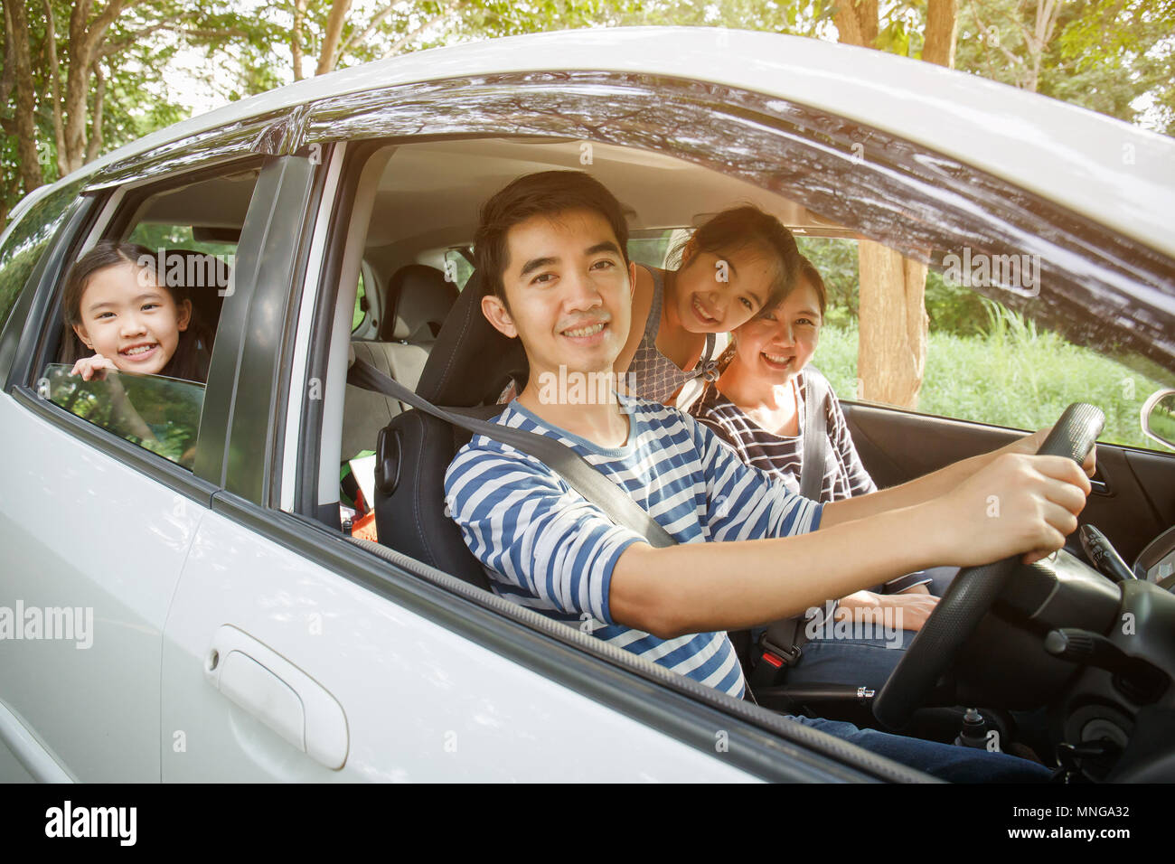 Happy Asian family on mini van are smiling and driving for travel on ...