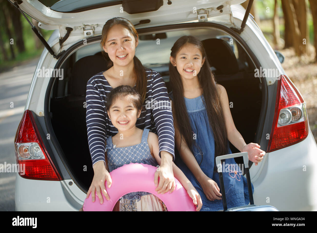 Happy Asian daughters and mother preparing for travel on vacation with ...