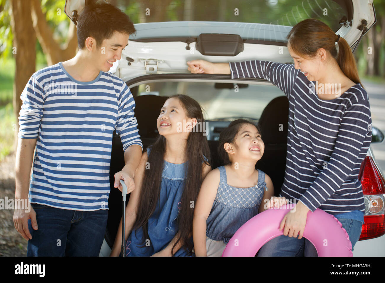 Happy Asian family on mini van are smiling and driving for travel on ...