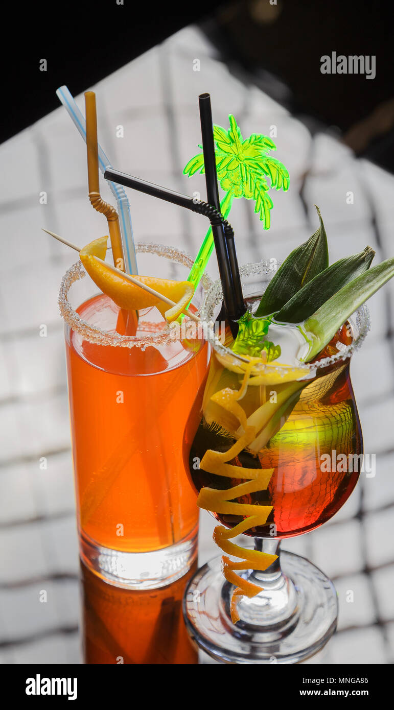 Glass with a cocktail on a glass table Stock Photo - Alamy