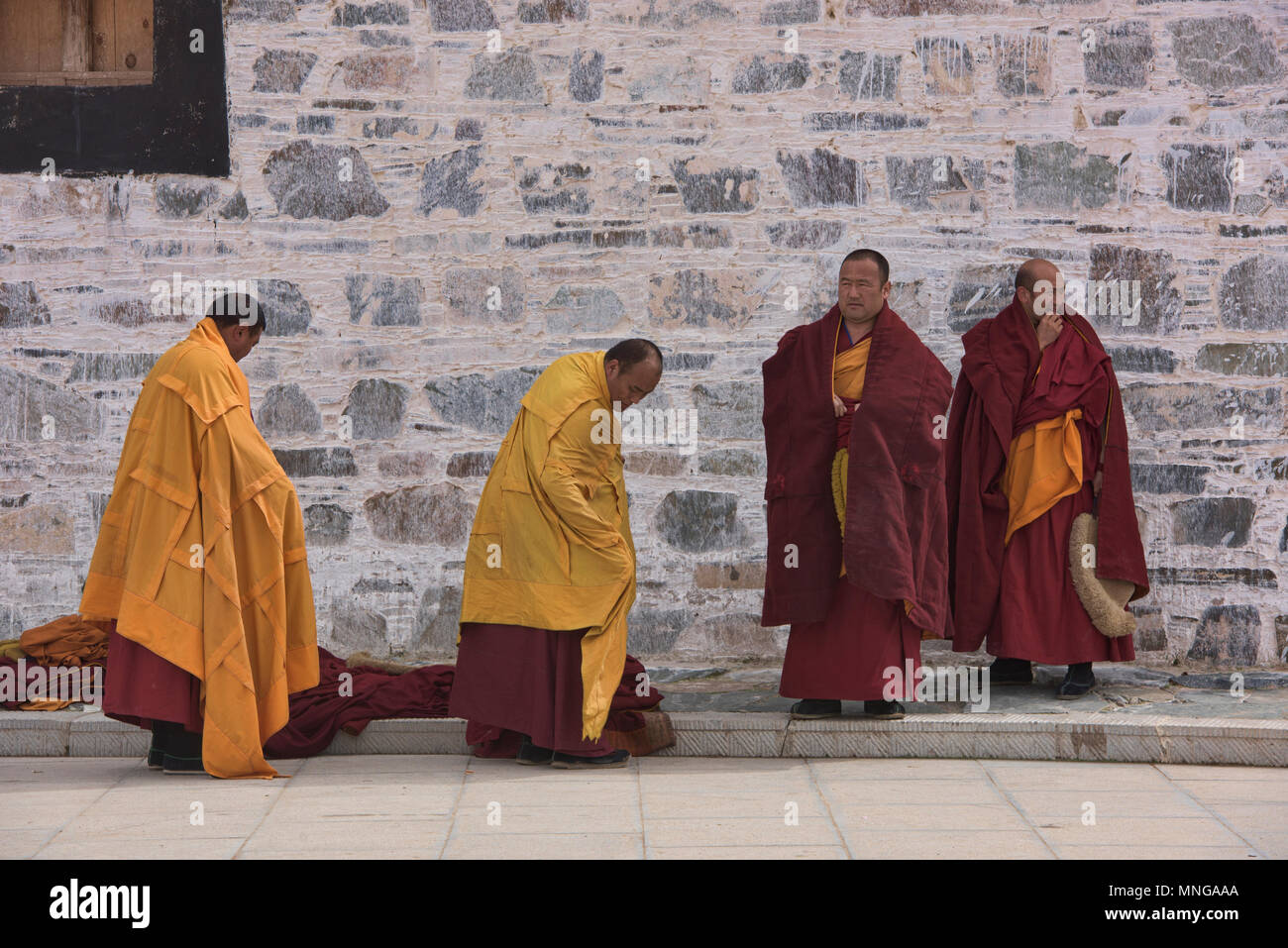 Gelukpa monks putting on their robes, Labrang Monastery, Xiahe, Gansu ...