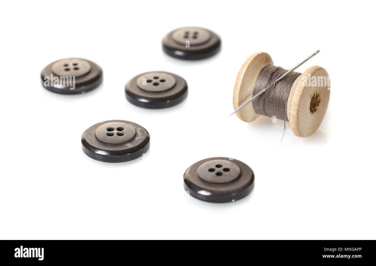 spool of thread and buttons on white isolated background Stock Photo ...