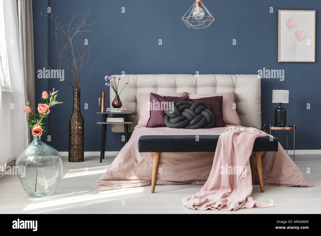 Tidy cozy hotel room with clean bed and fresh flowers Stock Photo - Alamy