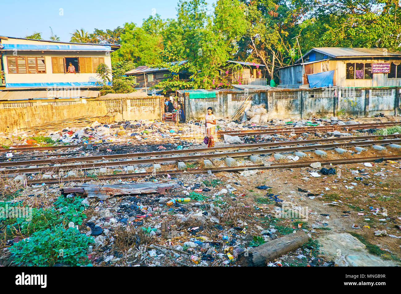YANGON, MYANMAR - FEBRUARY 16, 2018: The young girl crosses the ...
