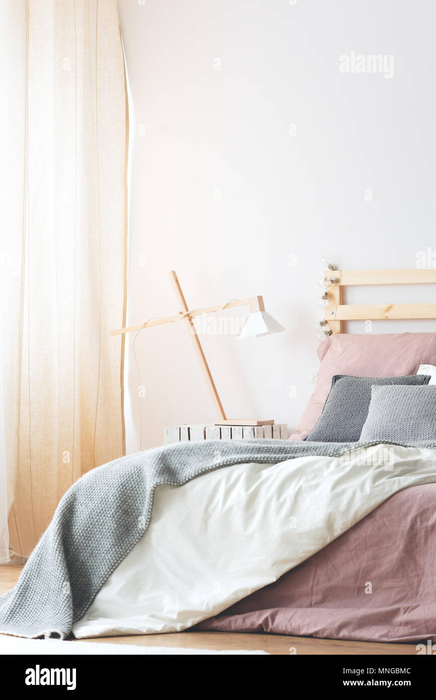King-size bed with pastel bedding in white modern bedroom Stock Photo ...