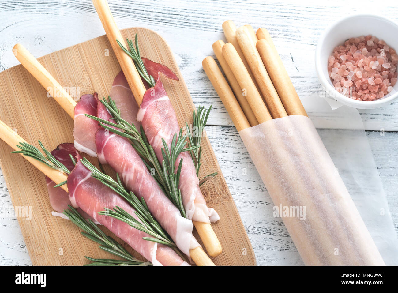 Breadsticks wrapped in ham Stock Photo - Alamy