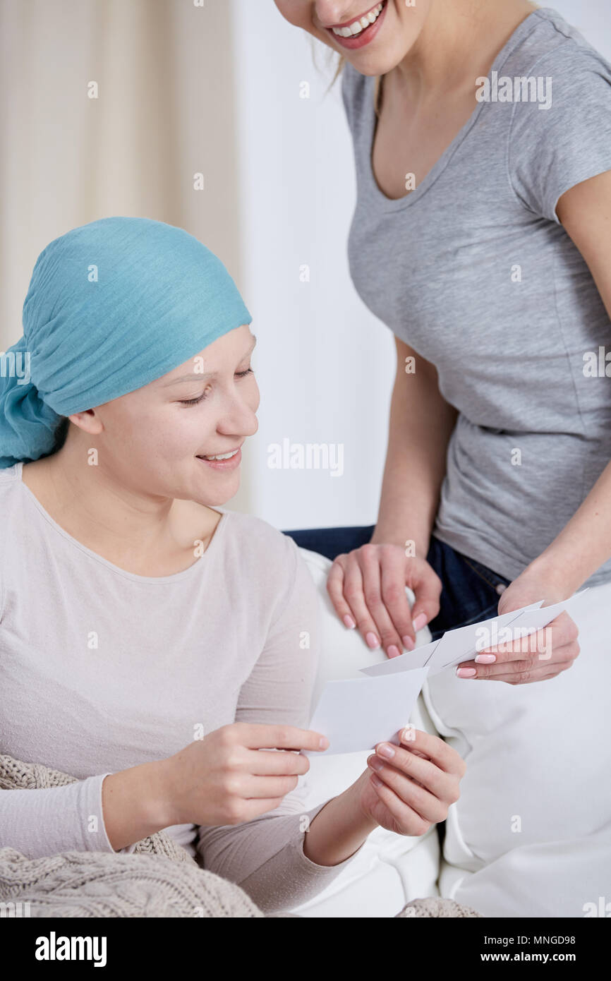 Positive cancer woman relaxing with friend at home Stock Photo - Alamy