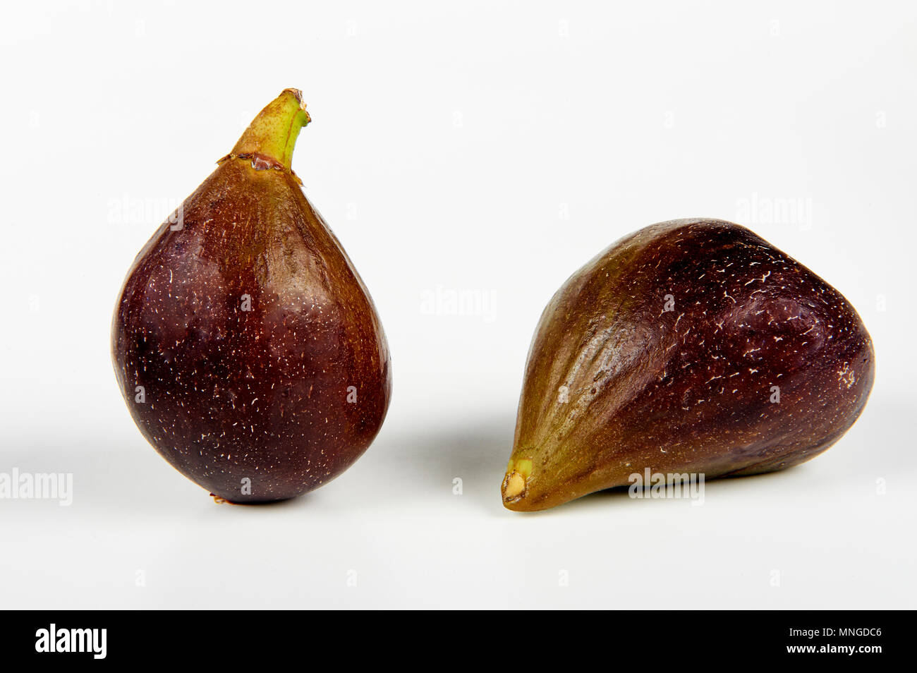 two figs on white background Stock Photo - Alamy