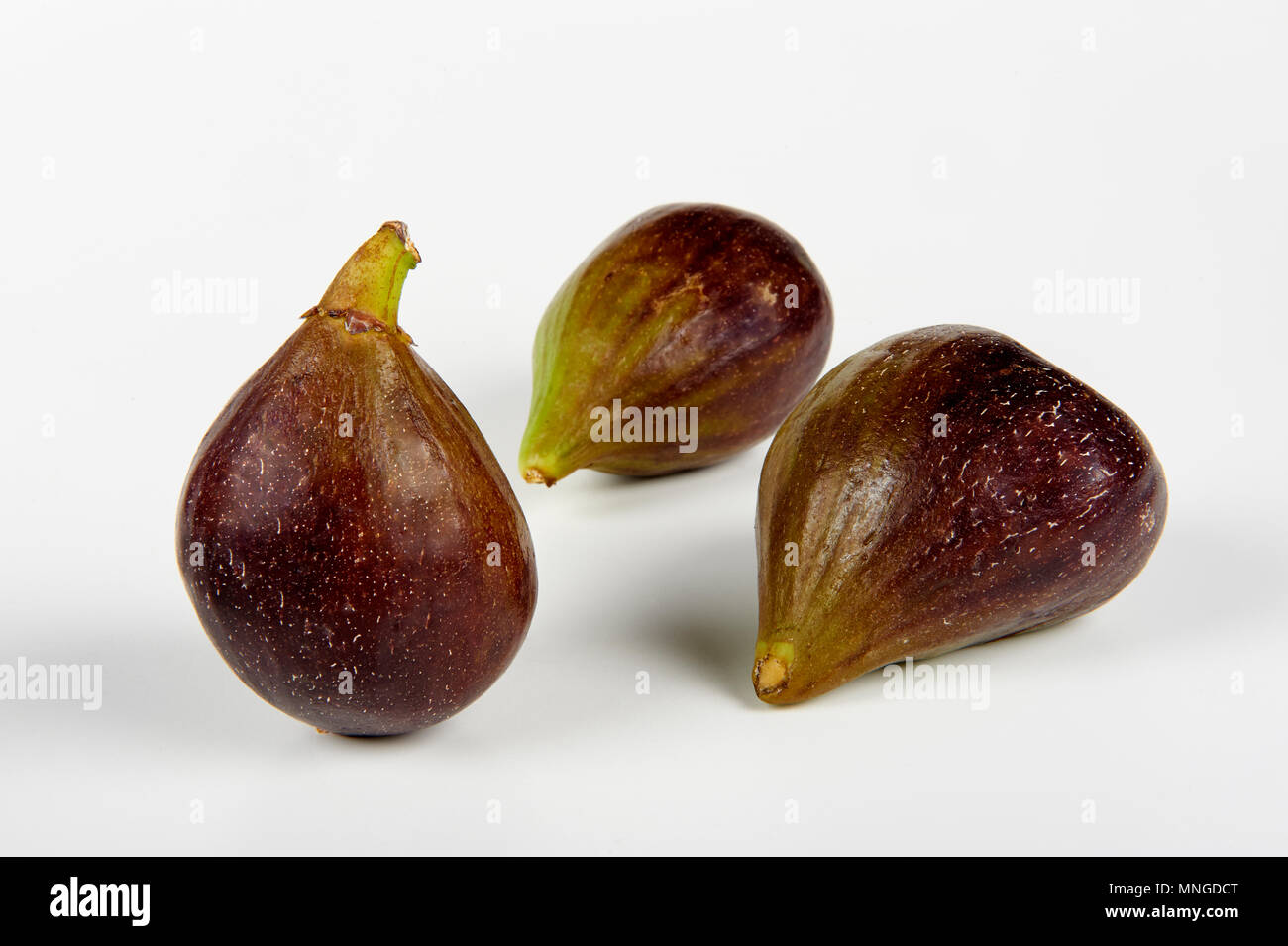 three figs on white background Stock Photo - Alamy