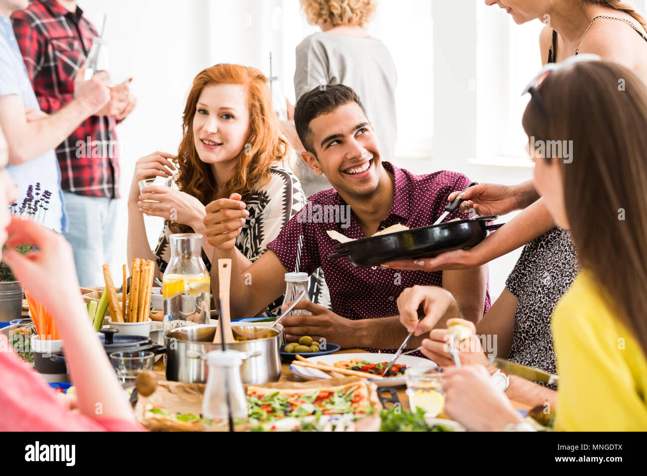 Young woman shares bio and fresh meal with her friend during dinner in ...