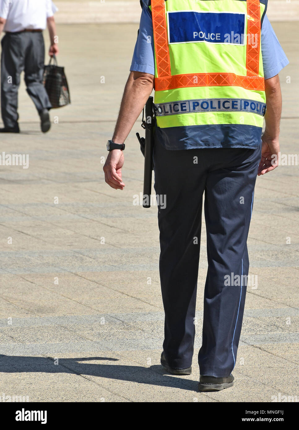 Police officer walks on the street Stock Photo - Alamy