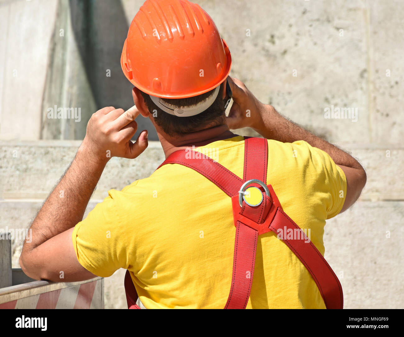 Construction worker makes a call on his mobile phone Stock Photo - Alamy