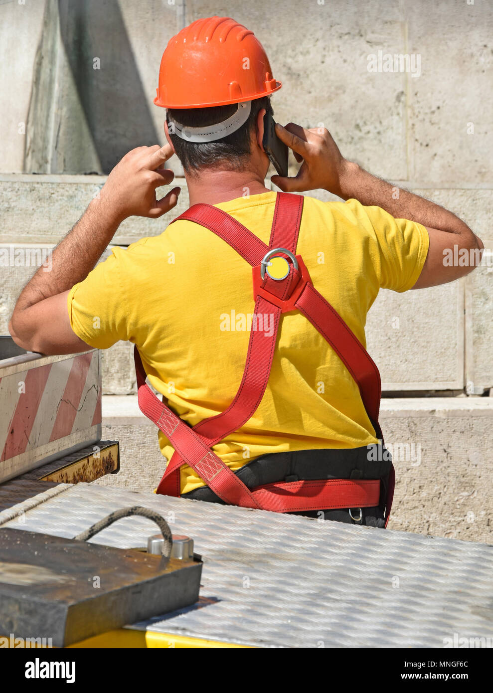 Construction worker makes a call on his mobile phone Stock Photo - Alamy