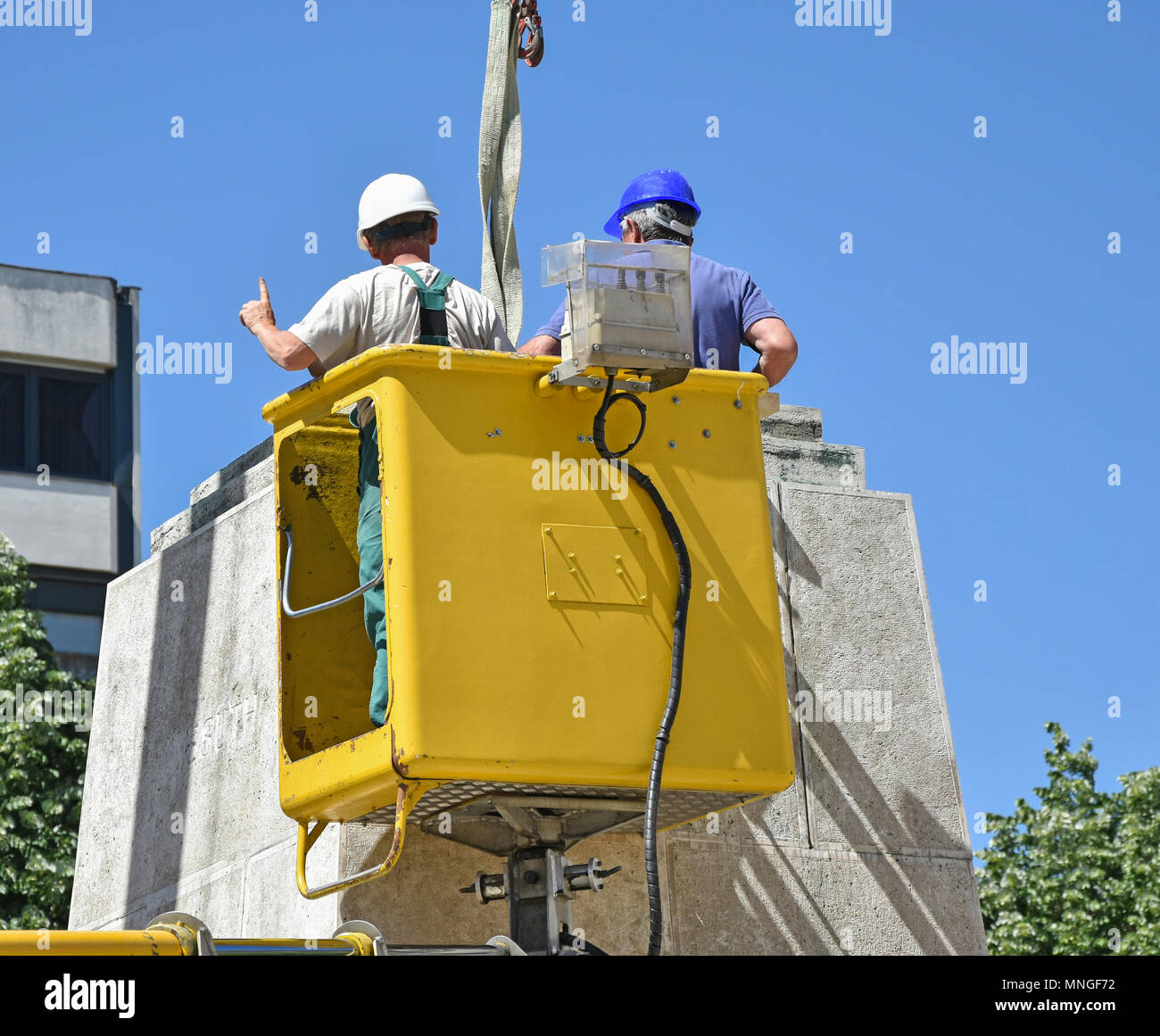 Construction workers outdoor in a lift Stock Photo - Alamy
