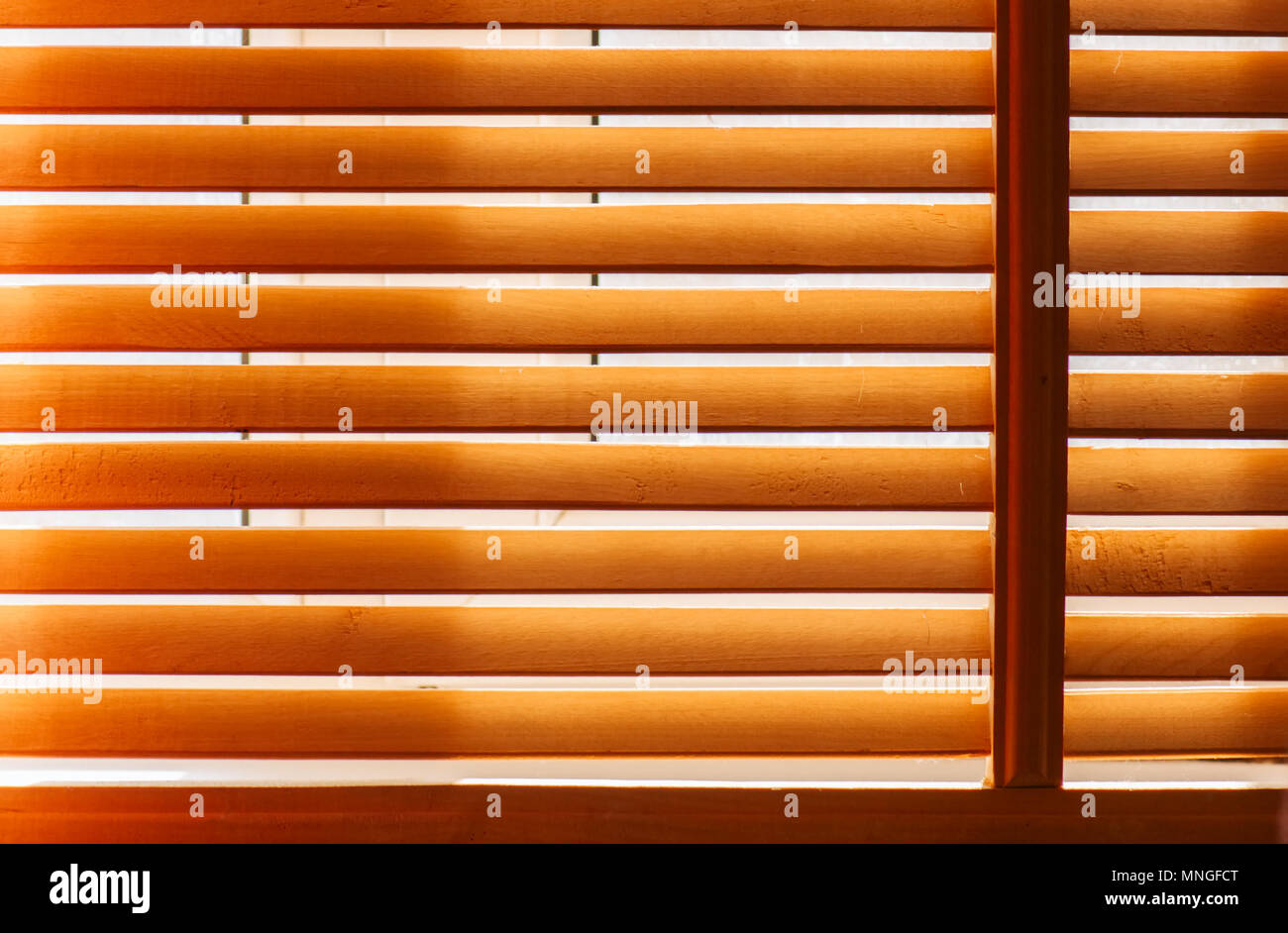 Wooden sun blinds on window with sun light Stock Photo - Alamy