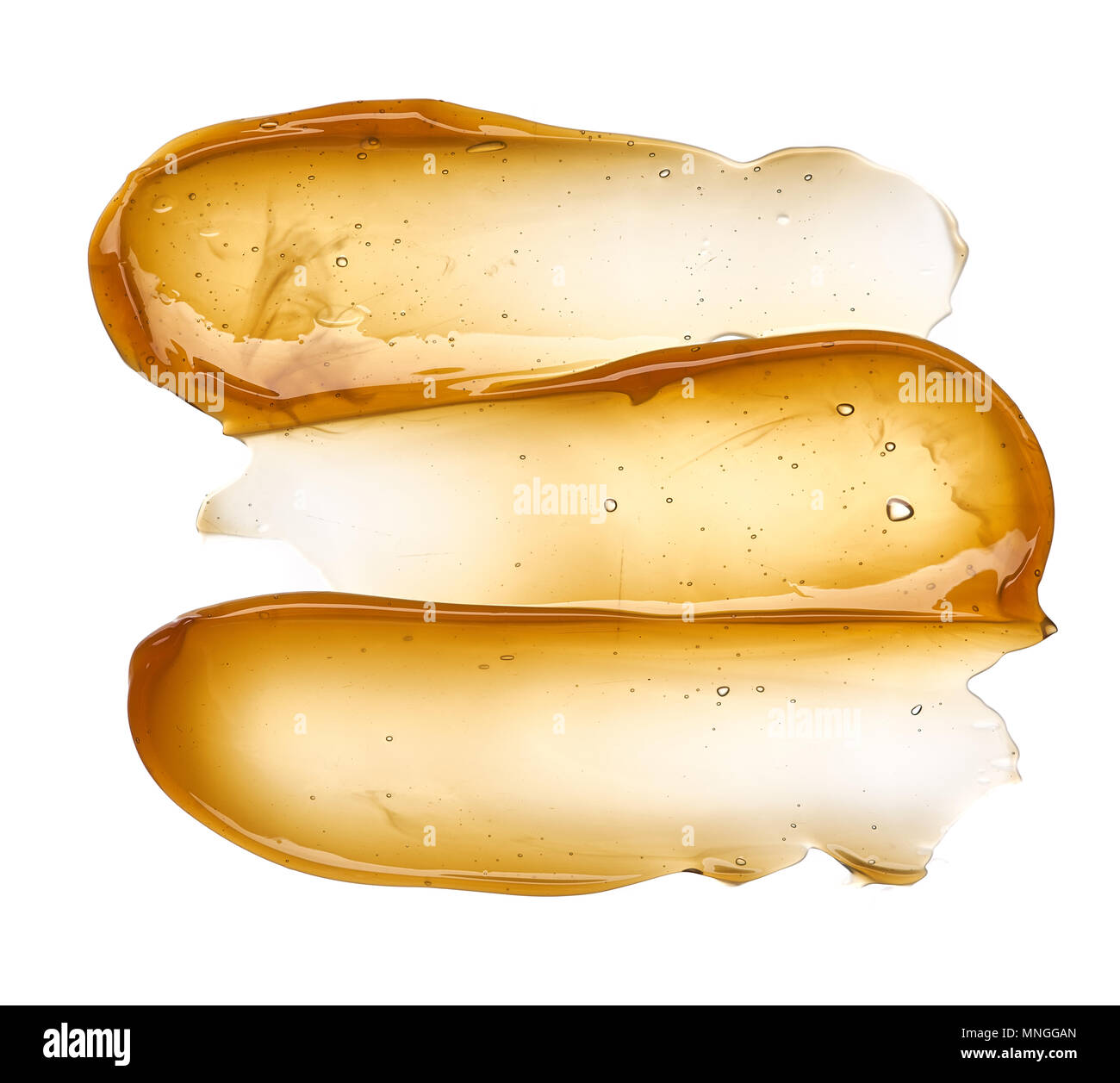 Transparent yellow smear of face cream or golden honey isolated on ...